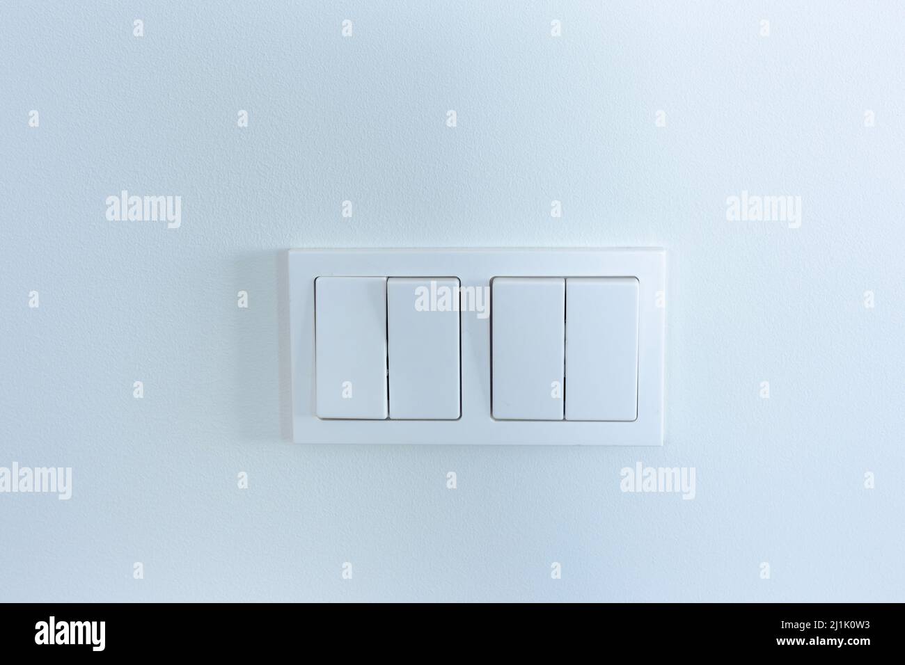 White light switches on a white wall Stock Photo - Alamy