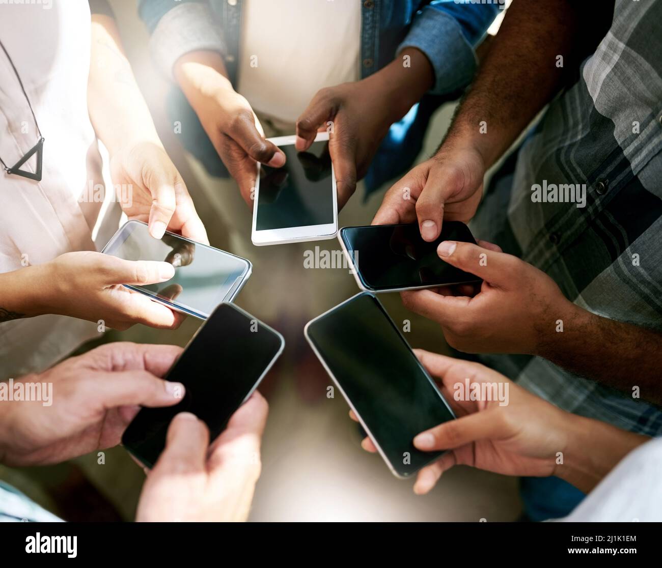 Just press send. Cropped shot of a group of colleagues using their ...