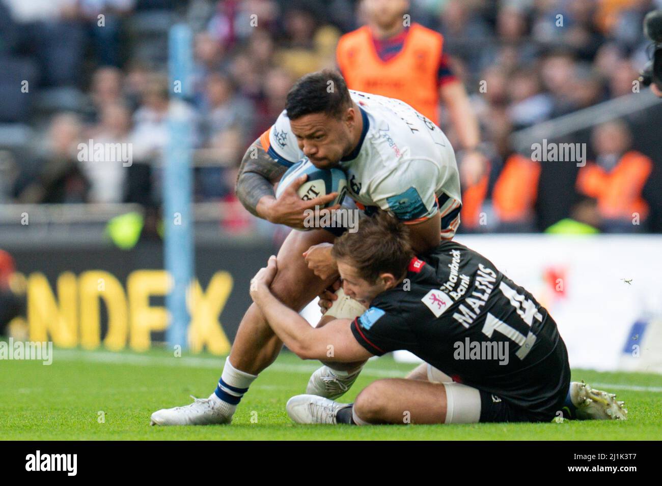 Jack Bates #11 of Bristol Bears is tackled by Max Malins #14 of ...