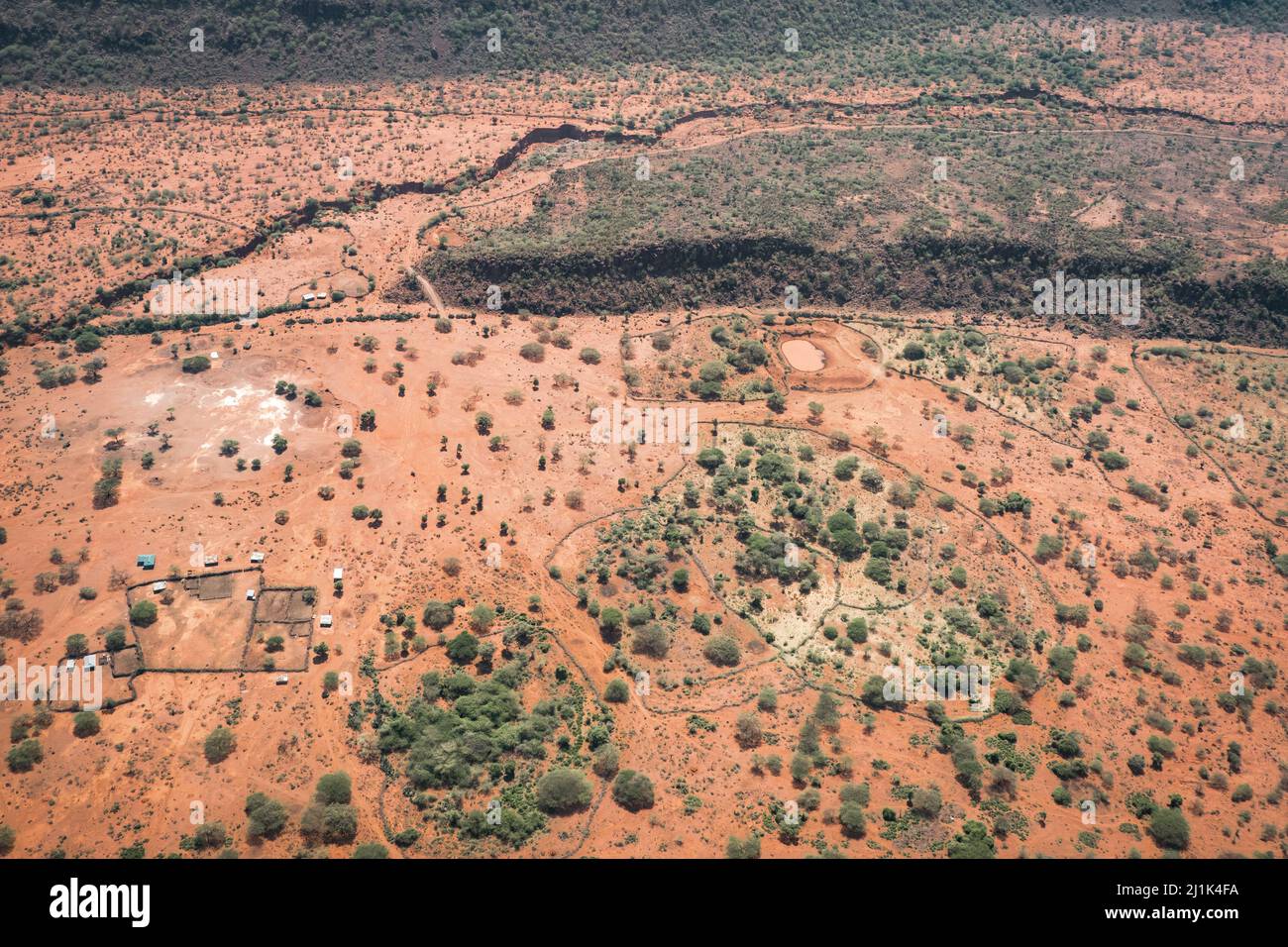 Aerial view of simple farms and family homes in the Maasai tribal area ...