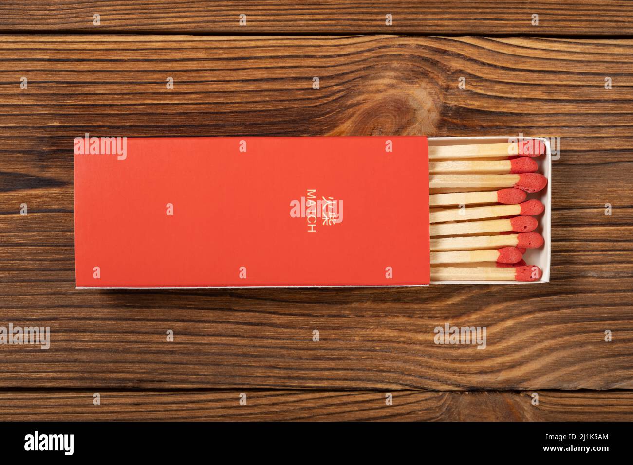 top view red color matchbox with red match sticks on a wood table Stock ...