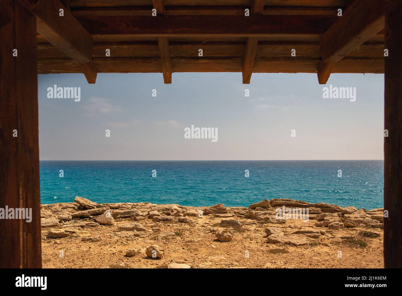 Seascape Cape Greco peninsula park in wooden frame, Cyprus. It is ...