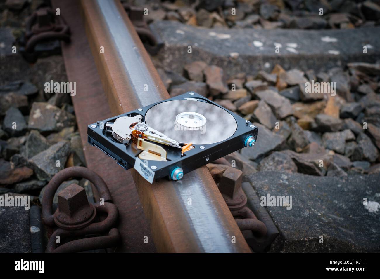 a hard disk stands on the rails of the railroad Stock Photo - Alamy