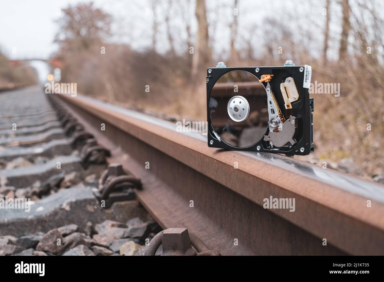 a hard disk stands on the rails of the railroad Stock Photo - Alamy