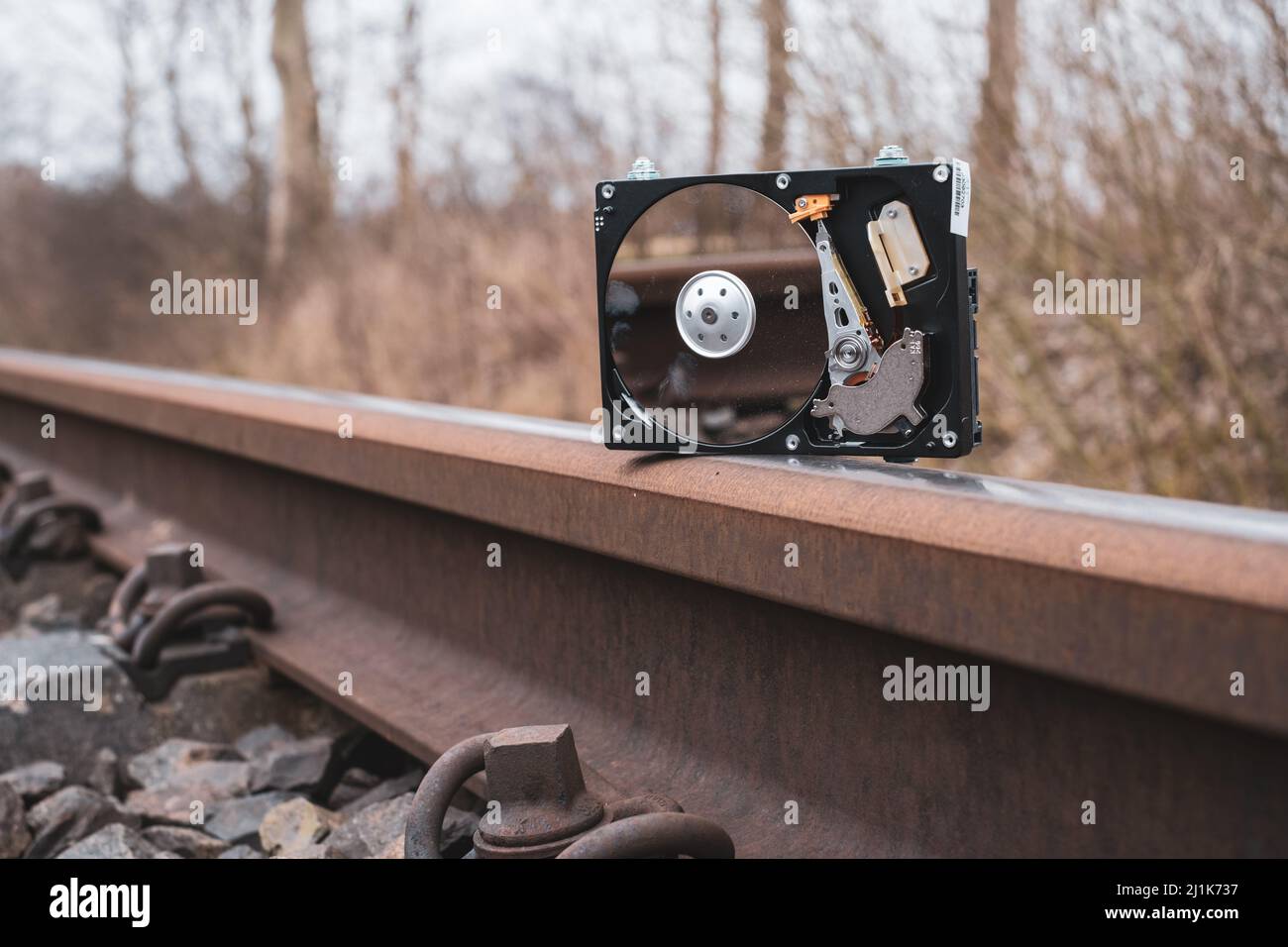 a hard disk stands on the rails of the railroad Stock Photo - Alamy