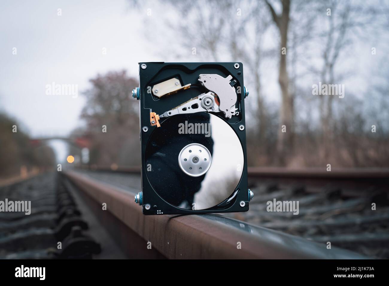 a hard disk stands on the rails of the railroad Stock Photo - Alamy