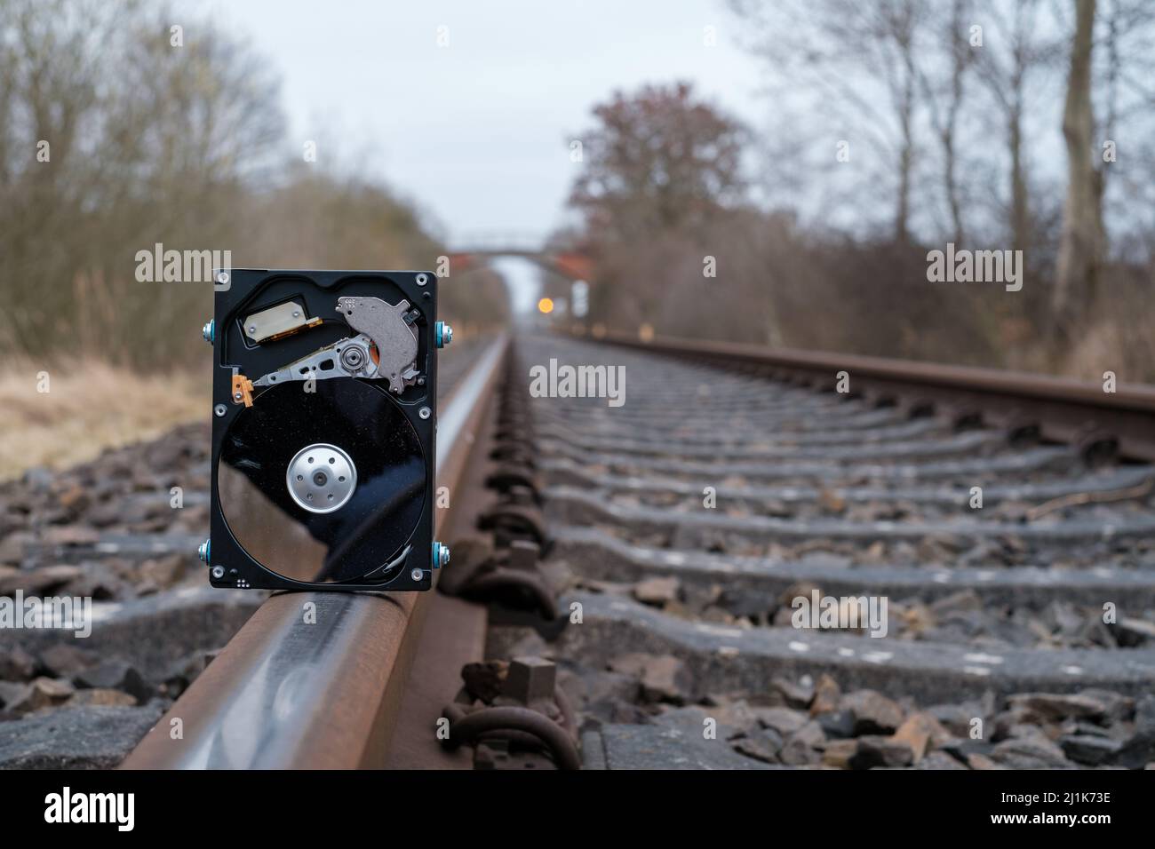 a hard disk stands on the rails of the railroad Stock Photo - Alamy