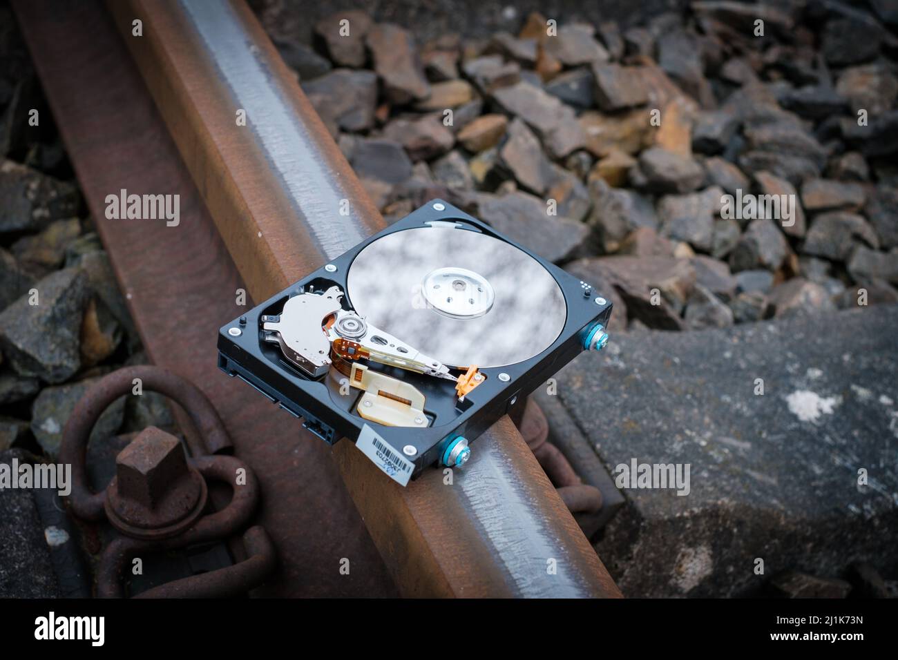 a hard disk stands on the rails of the railroad Stock Photo - Alamy
