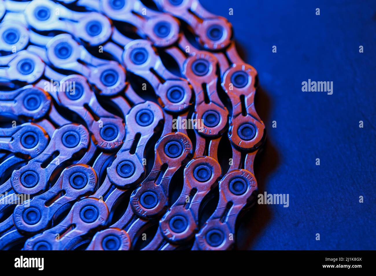 Patterns of a technological bicycle chain braided in a circle with blue ...