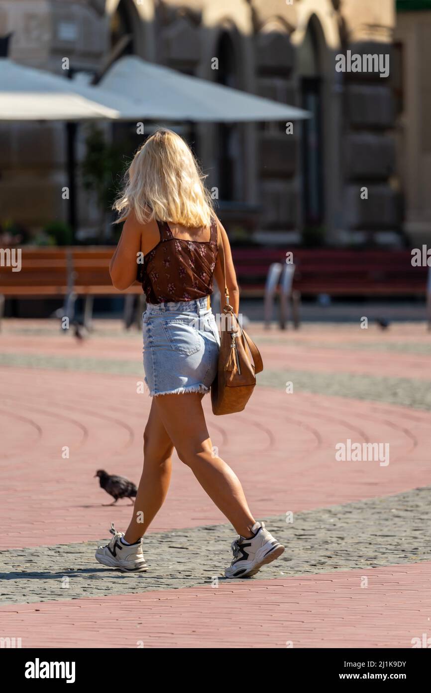 Woman walking on the street. Real people Stock Photo - Alamy