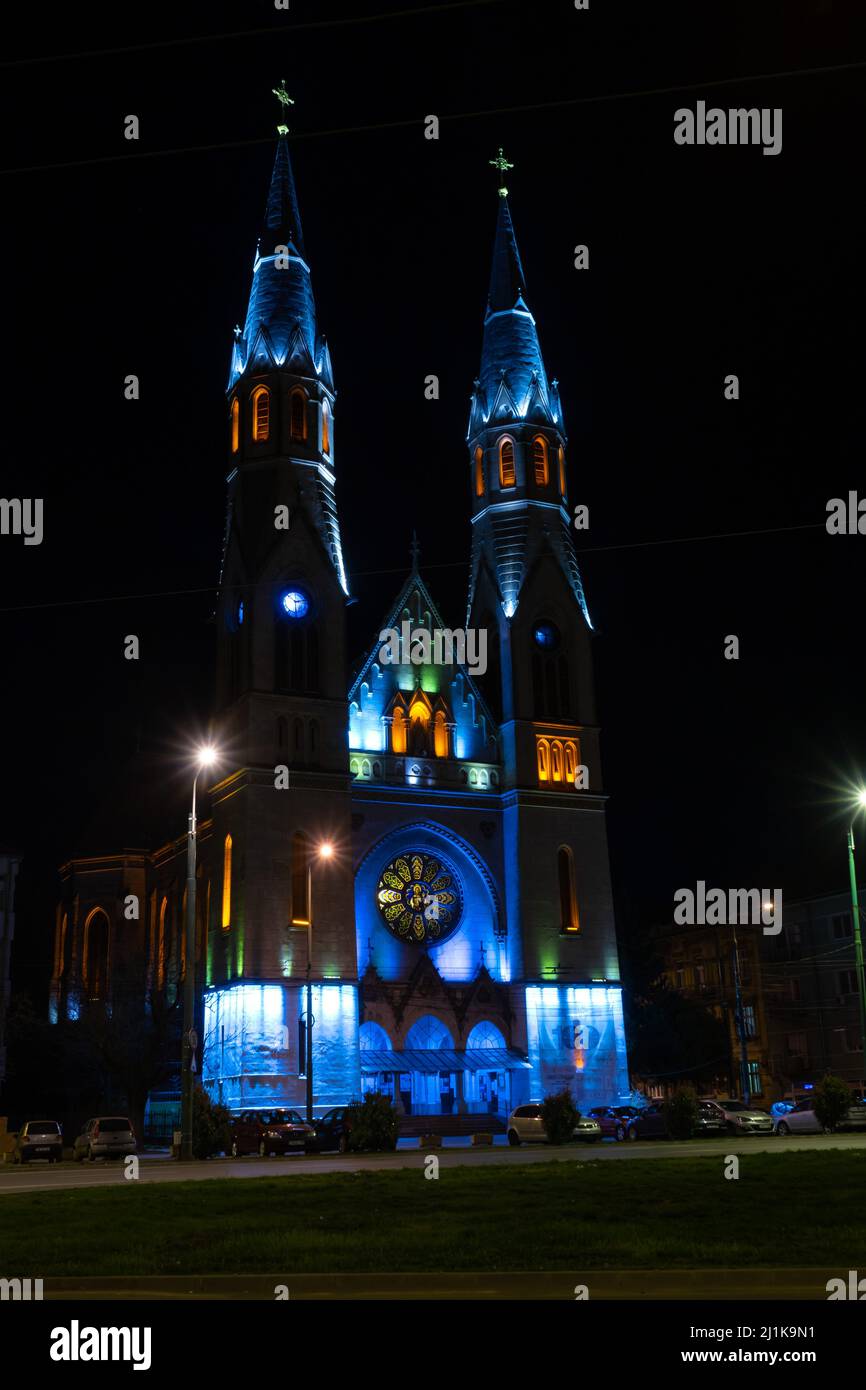 View of an illuminated church in the night. Sacred Heart of Jesus ...