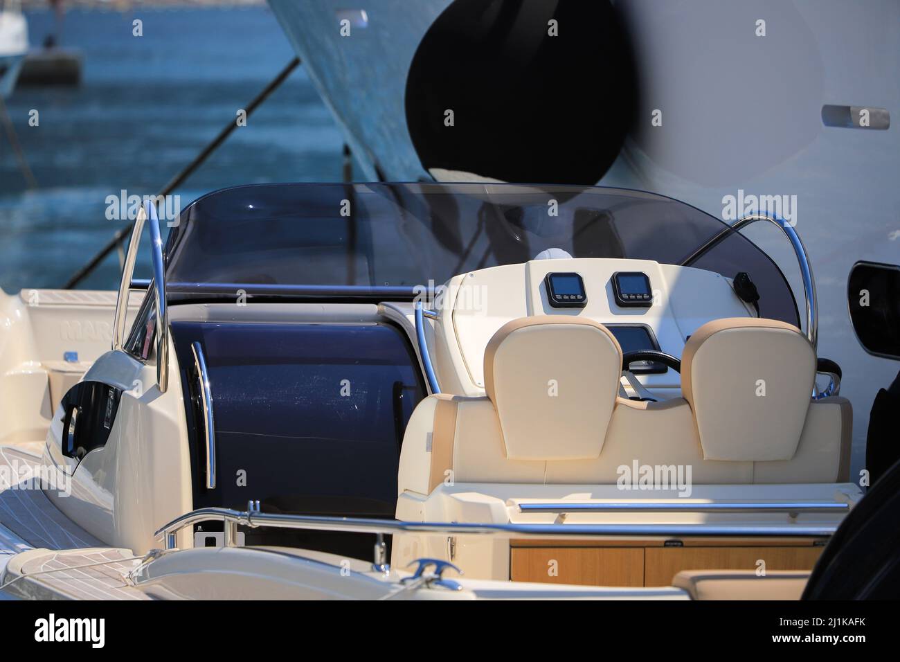 Cockpit boat moored near the luxury motor yacht on the sea Stock Photo ...