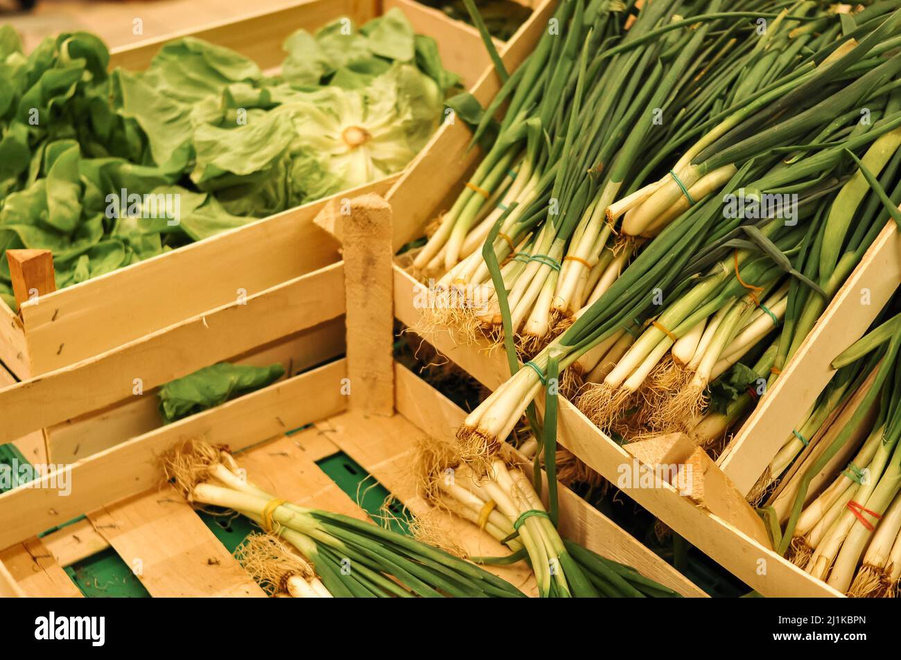 Greens in wooden boxes on the showcase in supermarket Stock Photo - Alamy
