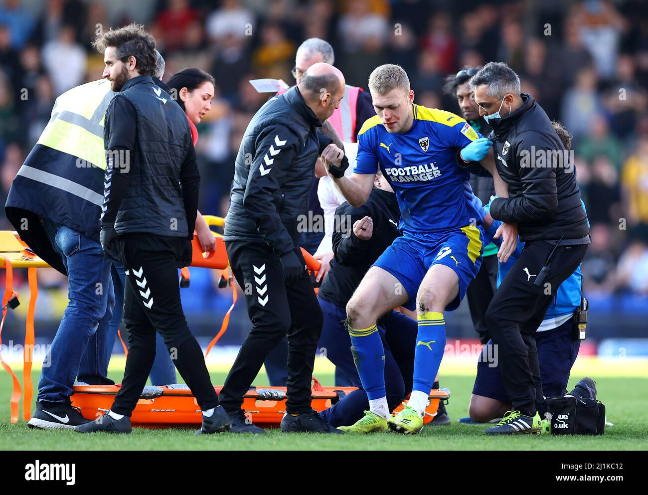 AFC Wimbledon's Sam Cosgrove is helped back to his feet during the Sky ...