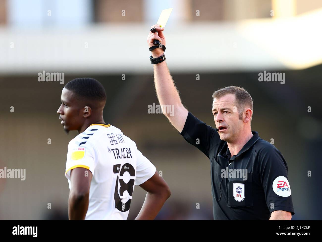 Cambridge United's Shilow Tracey receives a yellow card from referee ...