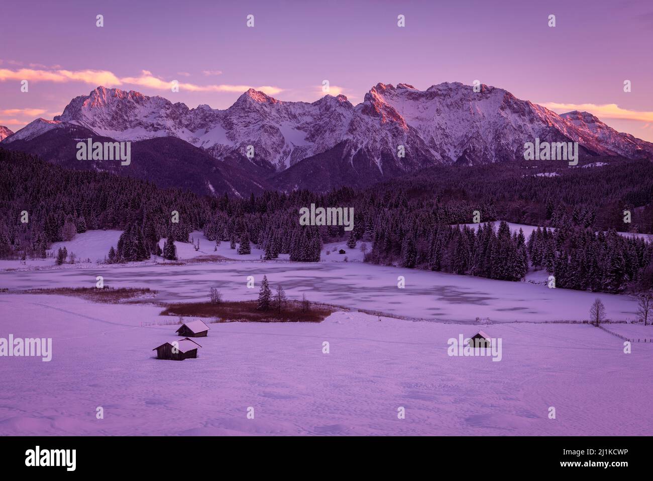 Alpenglow at dusk at the snowy winter landscape at Lake Gerold and the ...