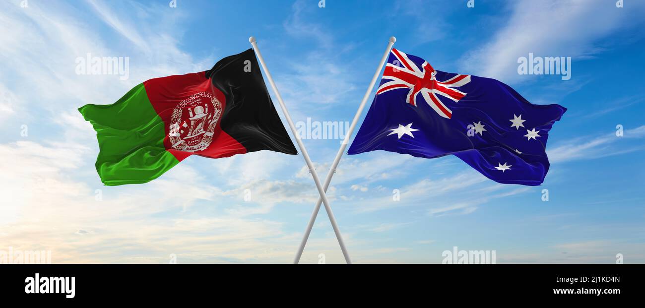 two crossed flags Afghanistan and Australia waving in wind at cloudy sky. Concept of ...
