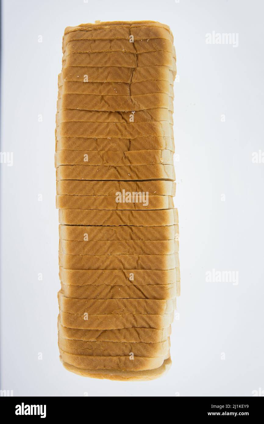The bottom view of an isolated long loaf of American sliced white bread ...