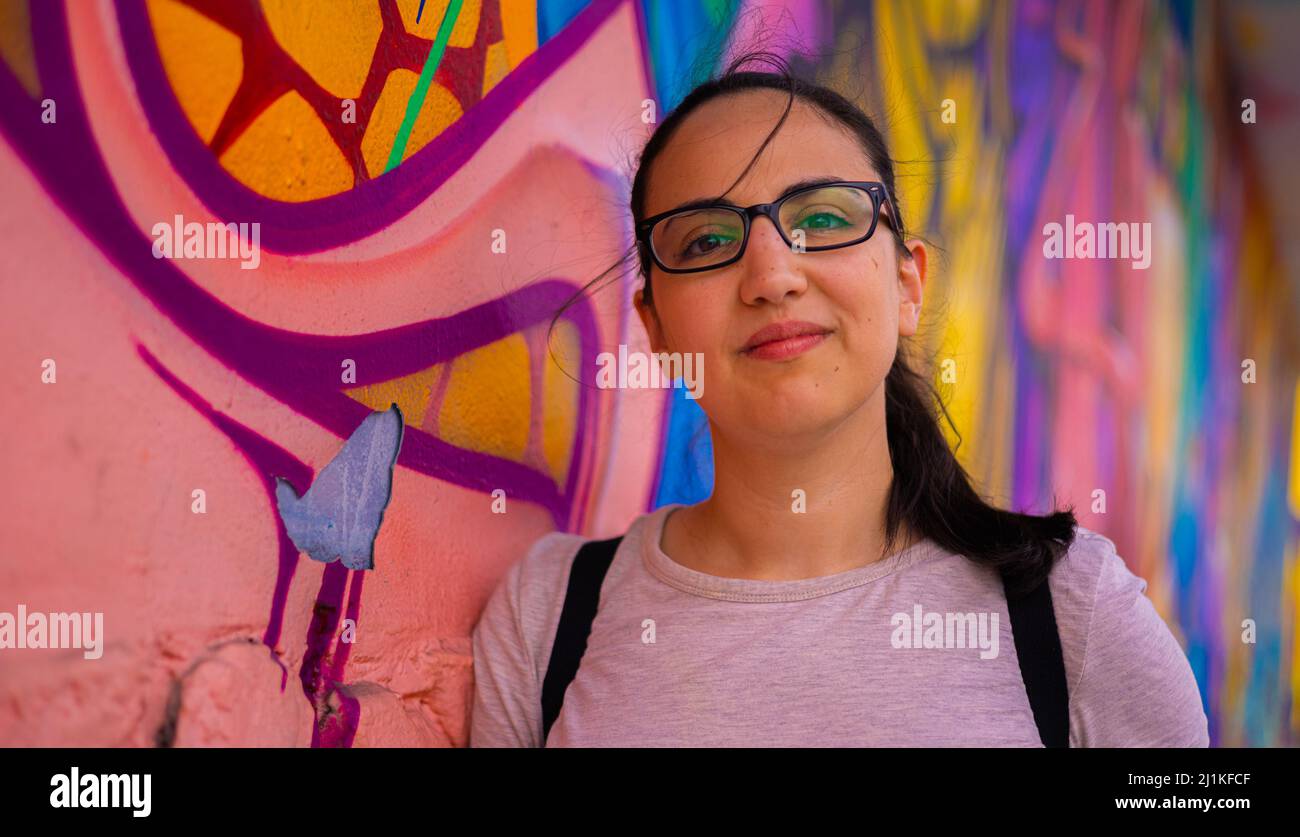 Street style photo shoot with a young pretty woman in the colorful ...