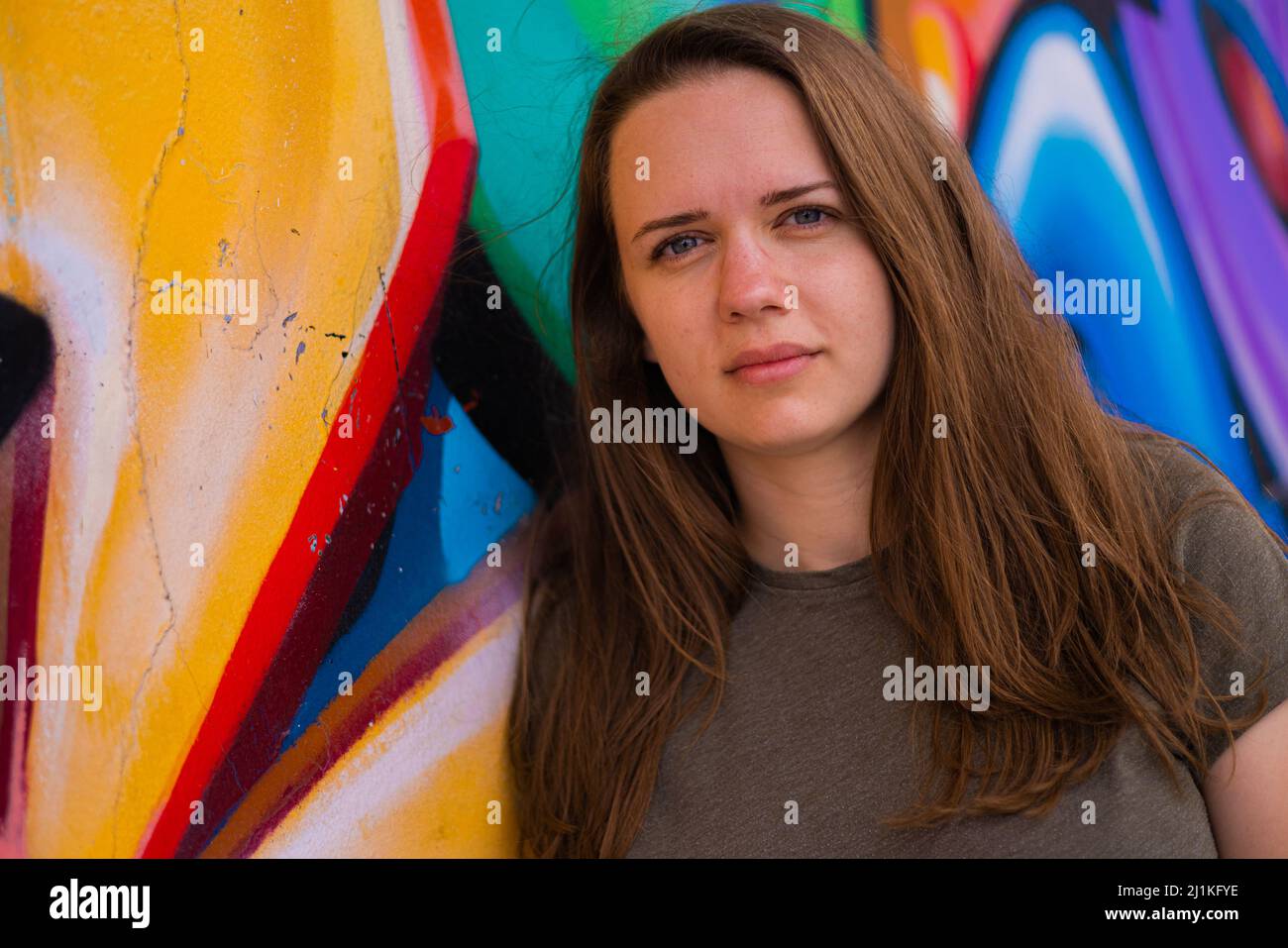 Street style photo shoot with a young pretty woman in the colorful ...