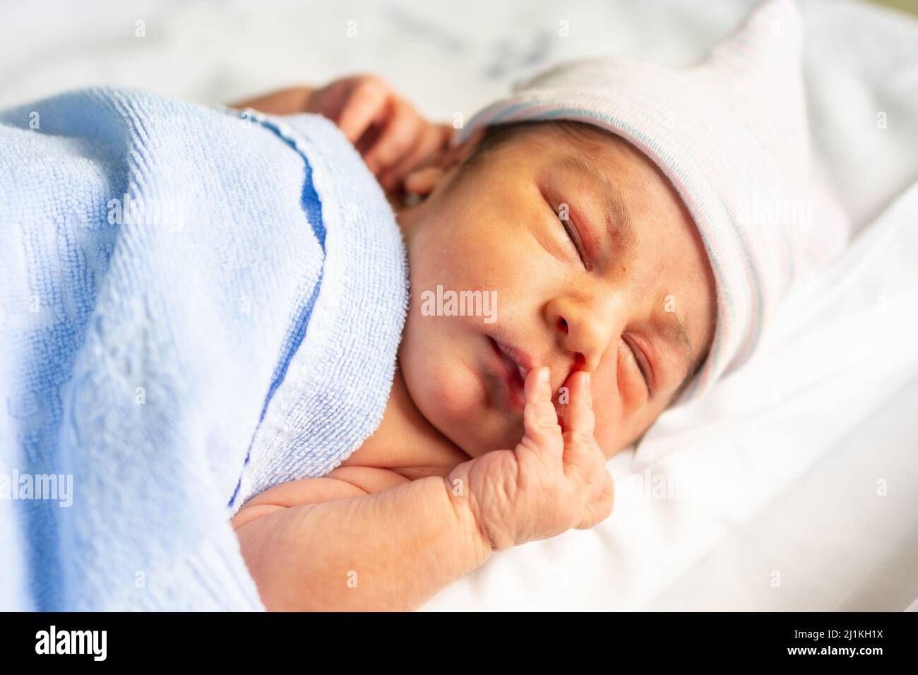 A photo of a newborn boy asleep in the hospital, first day of life ...