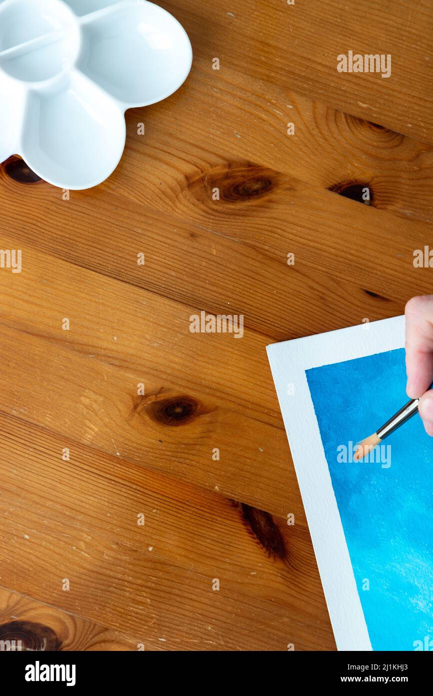 A flat lay style image of art accessories on a wooden style background ...