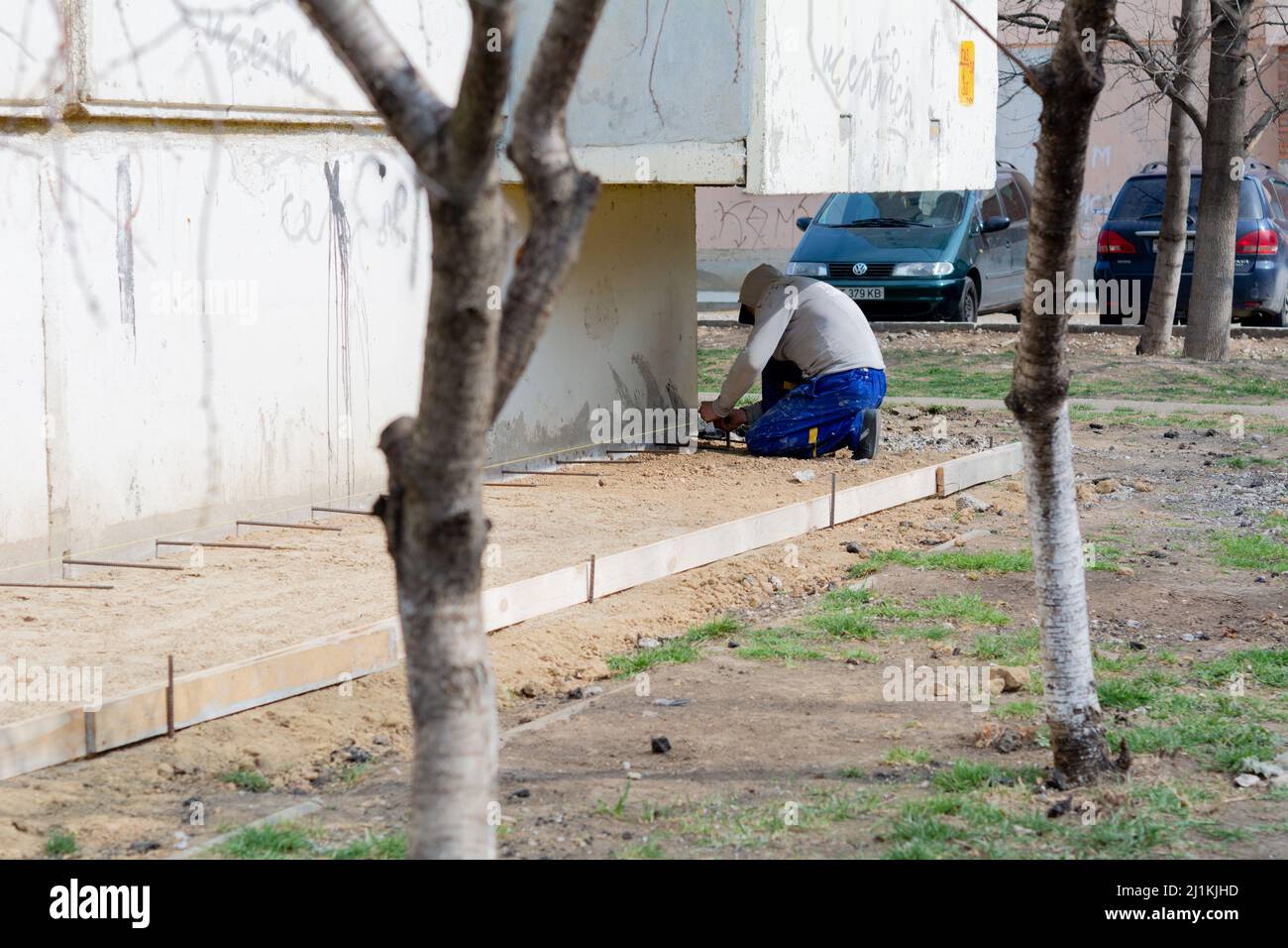 Foundation blind area preparing. An unknown worker makes basic markings ...