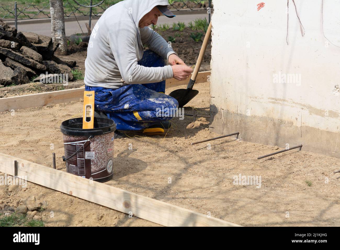 Foundation blind area preparing. An unknown worker makes basic markings ...