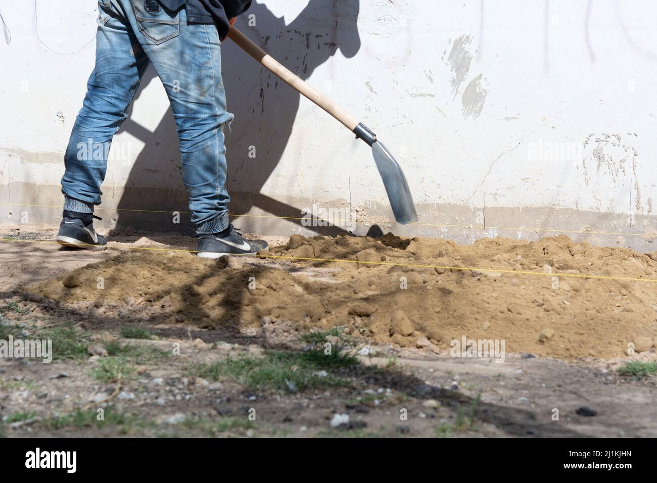 Foundation blind area preparing. An unknown worker of European ...