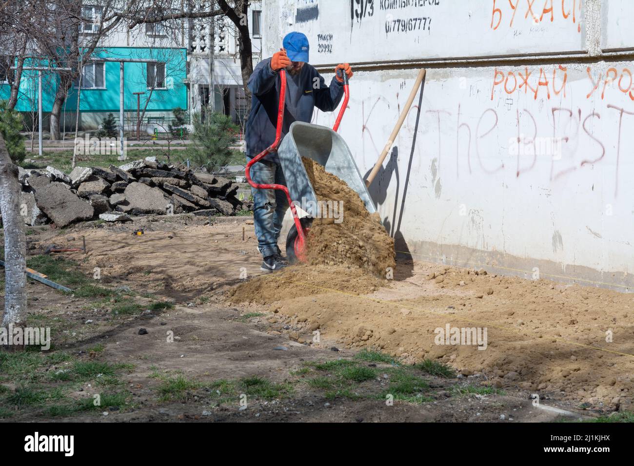 Foundation blind area preparing. An unknown worker of European ...