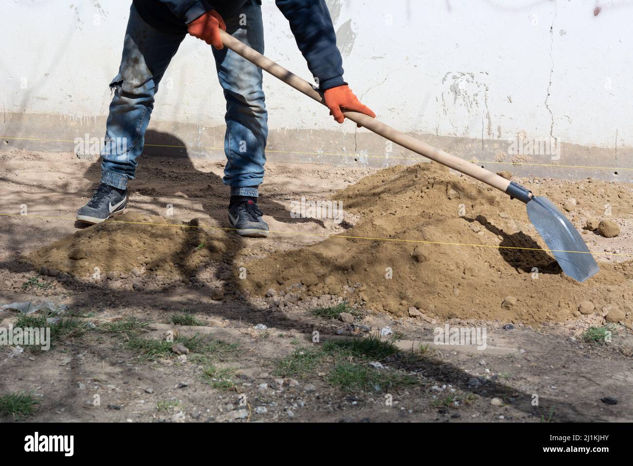 Foundation blind area preparing. An unknown worker of European ...