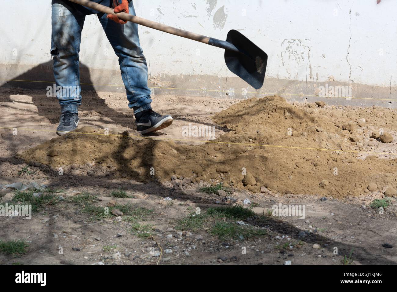 Foundation blind area preparing. An unknown worker of European ...