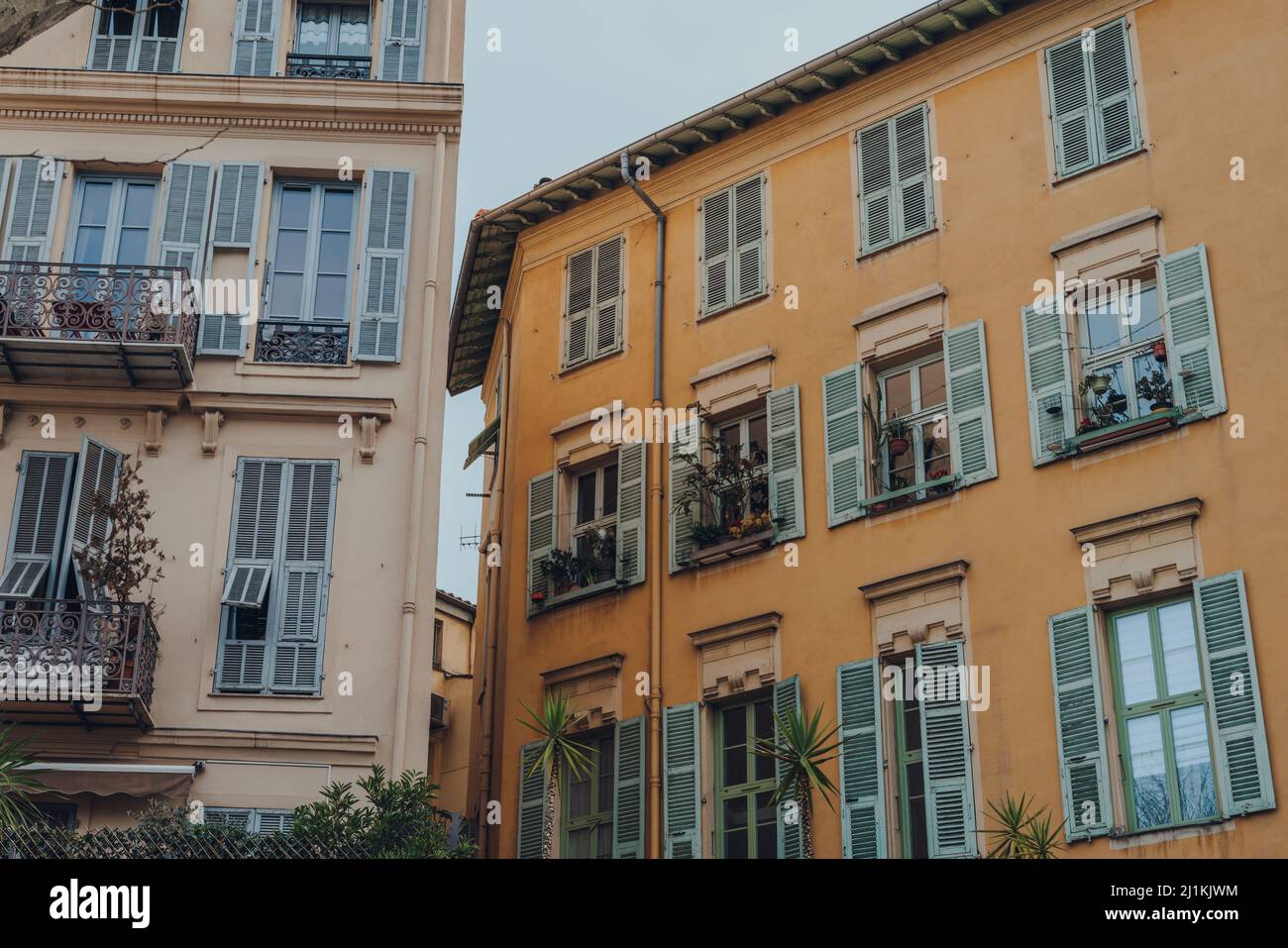 Exterior of a traditional residential buildings in Nice, France, plants ...
