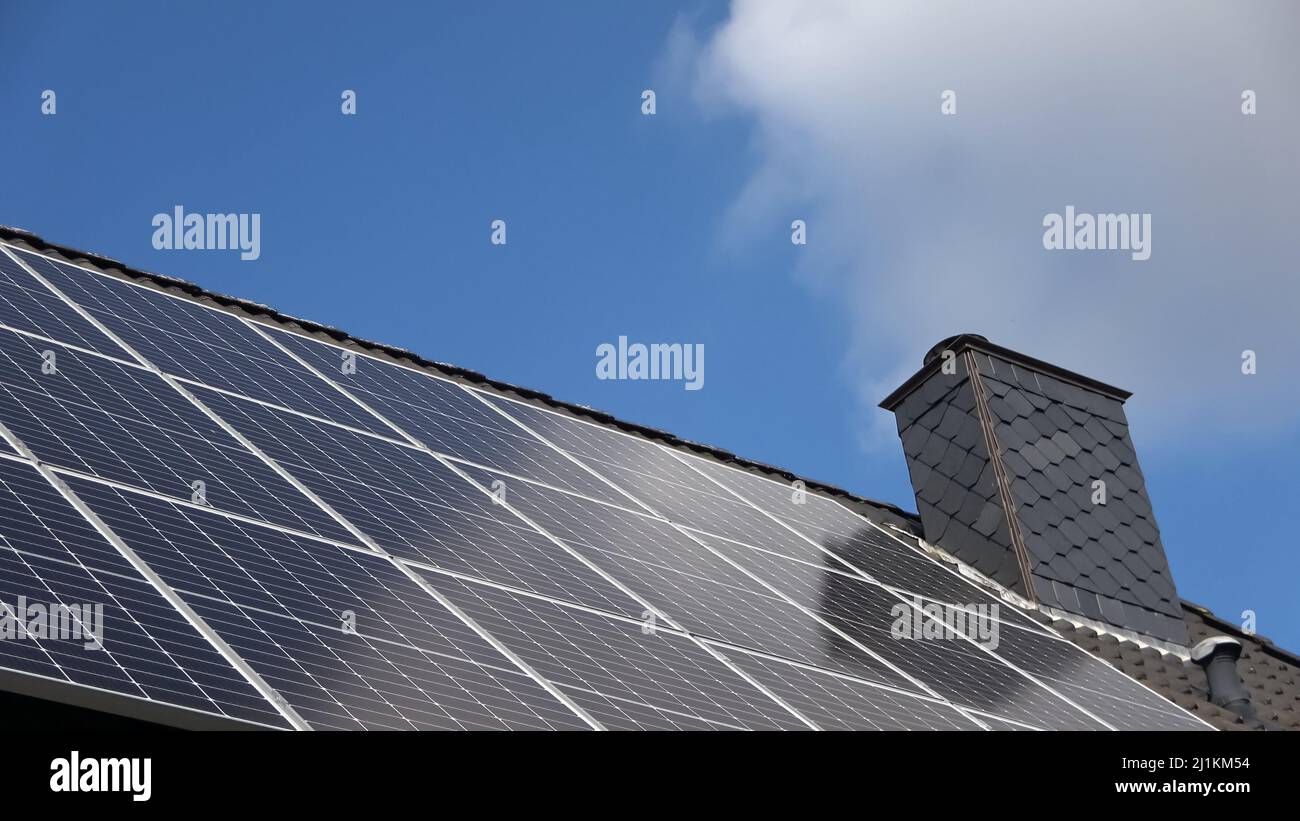 Solar panels producing clean energy on a roof of a residential house ...