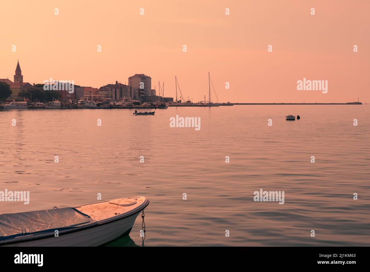 A photograph of a ship and a luxury yacht anchored in port. Beautiful ...