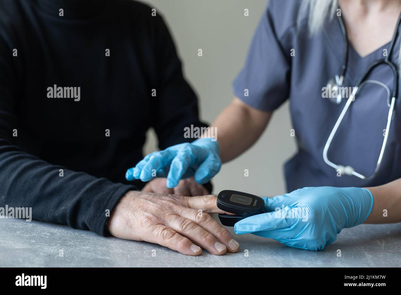 elderly man and nurse measuring pulse oximeter Stock Photo - Alamy