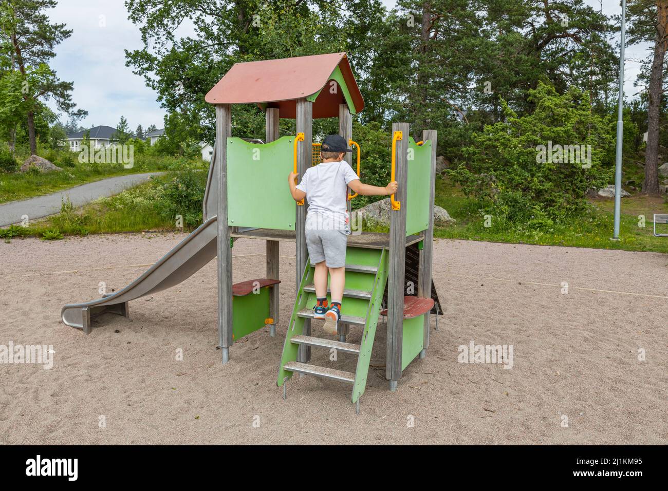Child climbing up slide hi-res stock photography and images - Alamy