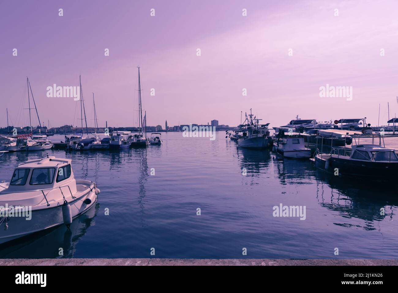 A photograph of a ship and a luxury yacht anchored in port. Beautiful ...