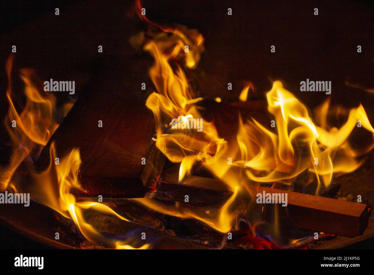 A closeup photo of wood stakes burning for warmth Stock Photo - Alamy