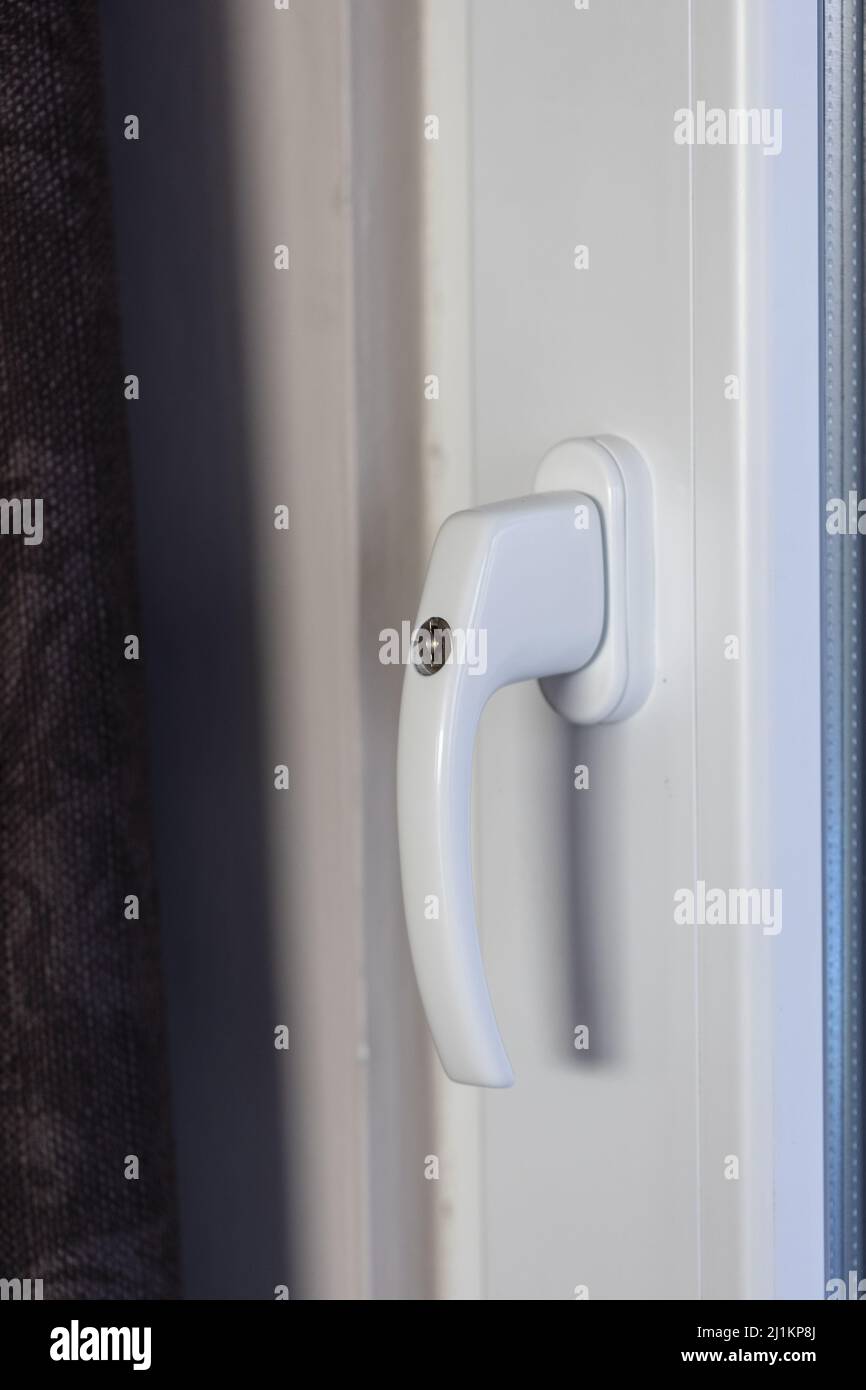 A vertical photo of a white door handle Stock Photo - Alamy
