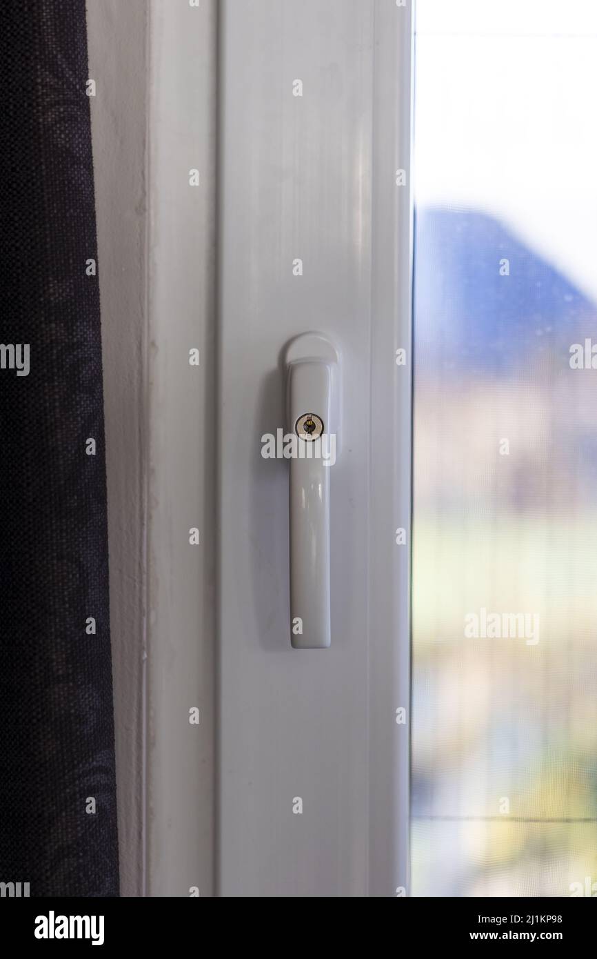 A vertical photo of a white door handle Stock Photo - Alamy