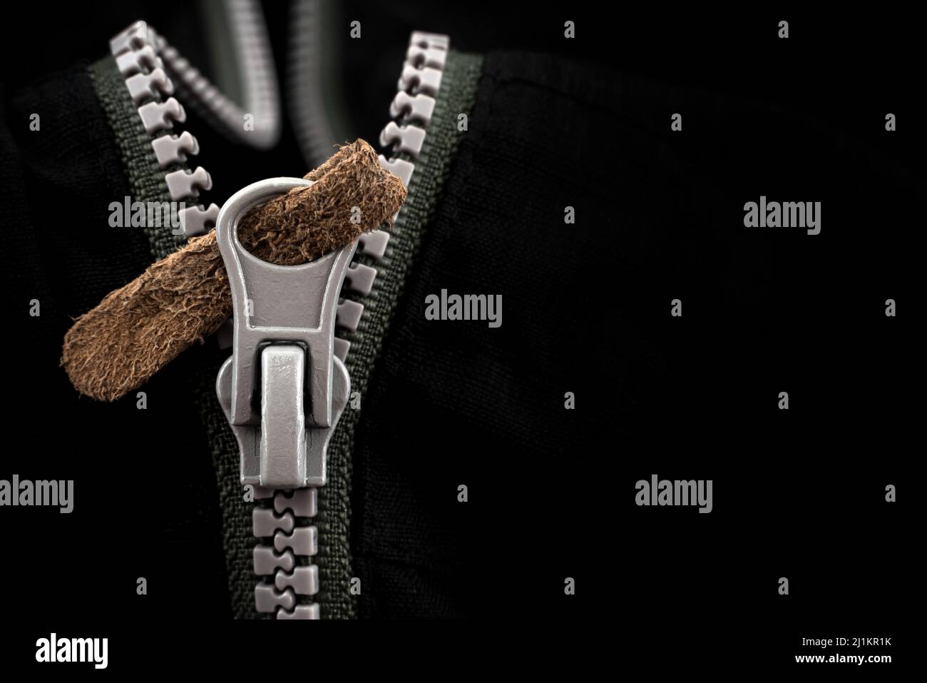 Lock with a gray zipper on black clothes close-up. Jacket clasp Stock ...