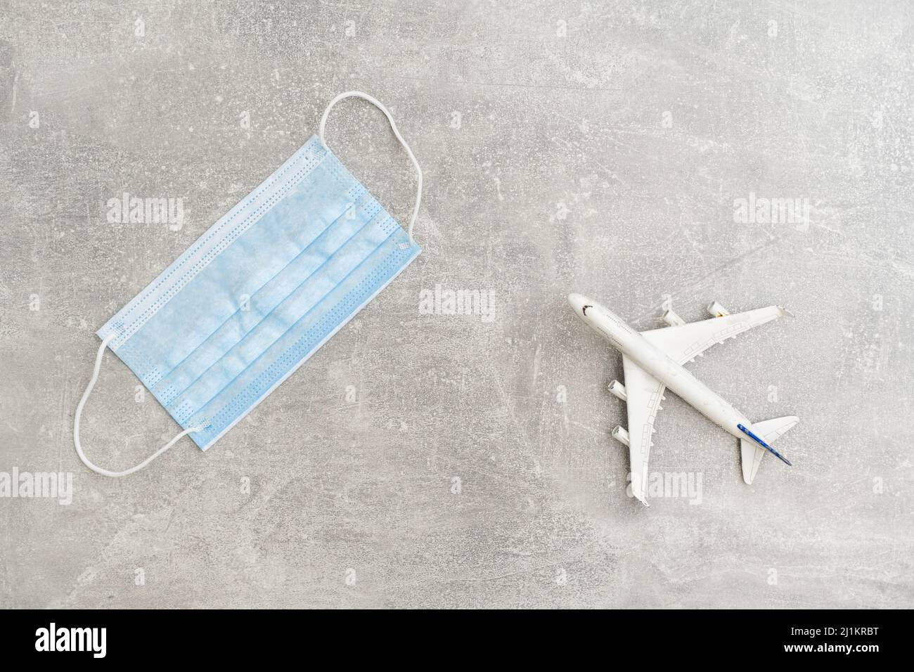 Airplane in flight with a medical mask. Concept - observance of safety ...