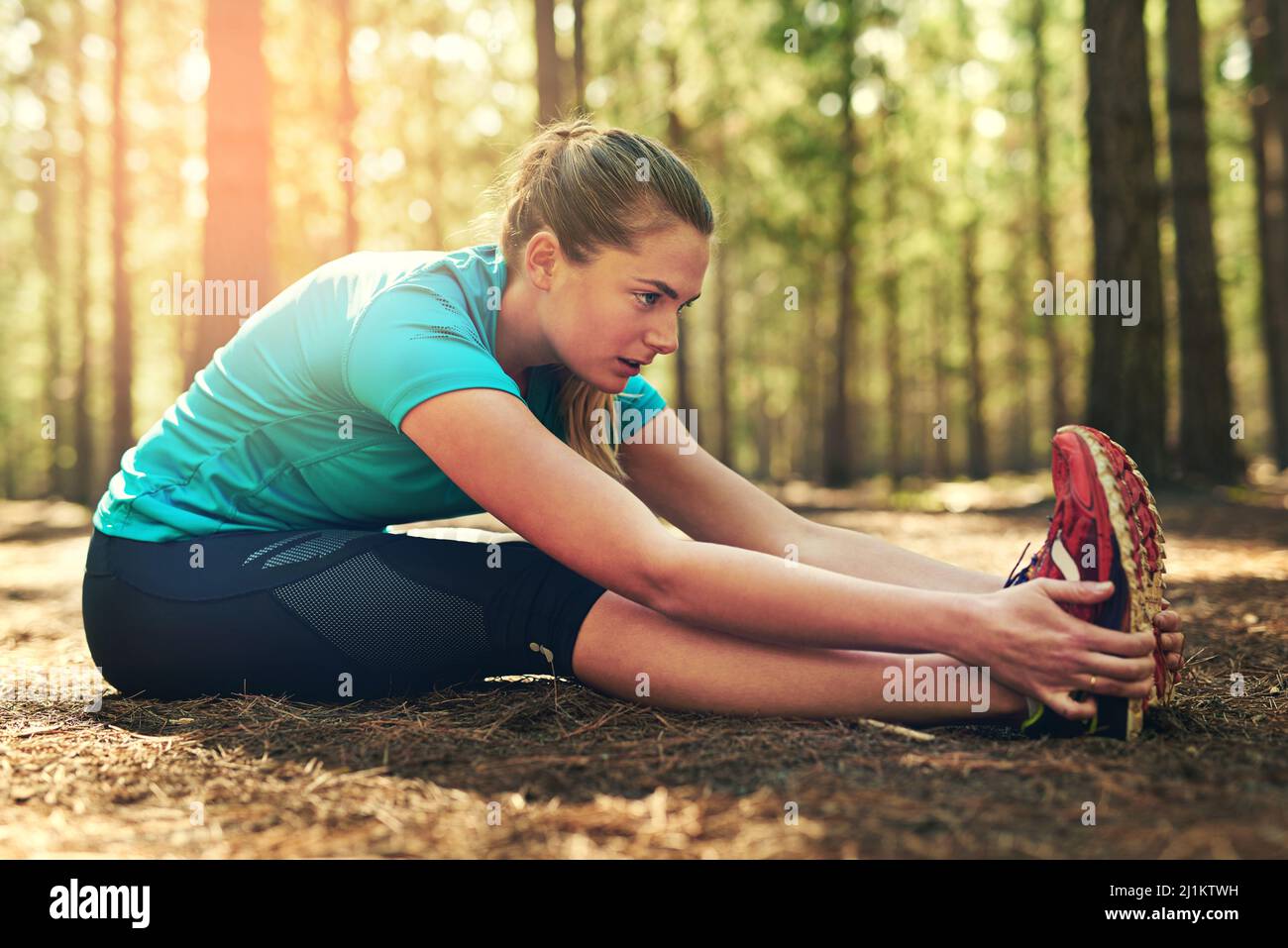 I stretch to prevent injuries. Shot of a sporty young woman doing ...