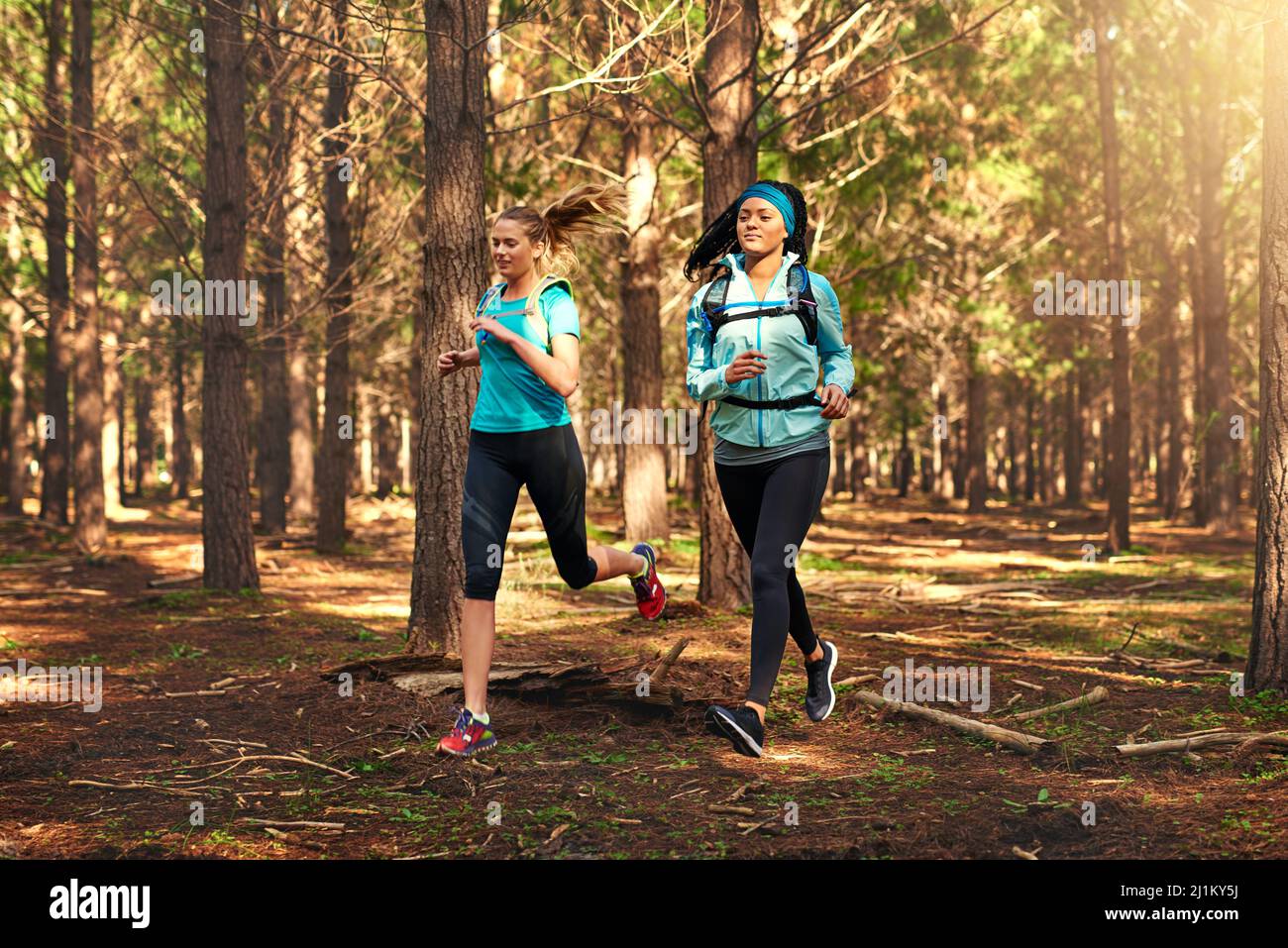 Our favorite place to exercise is in nature. Shot of two sporty young ...