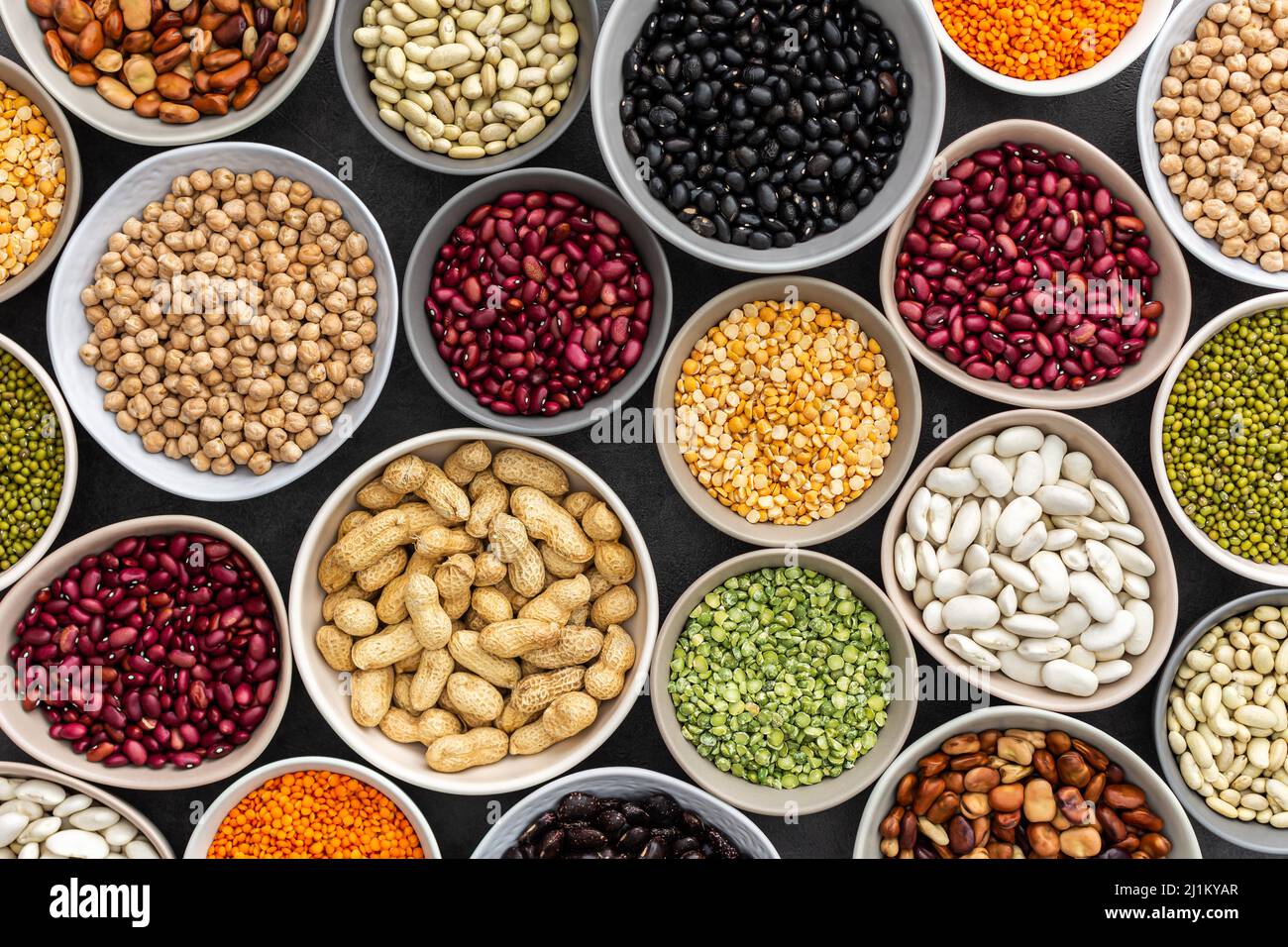 Different types of legumes in bowls, green with yellow peas and mung ...