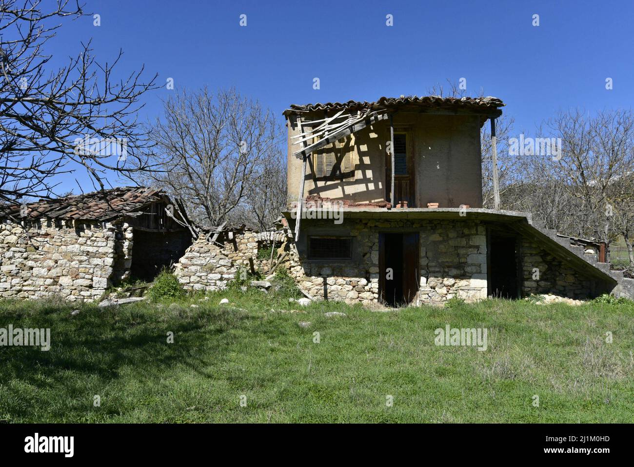 Rural landscape with view of an old abandoned stone house in the ...