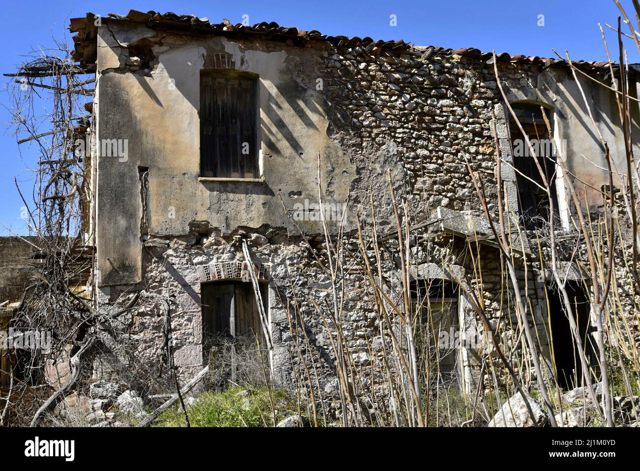 Rural landscape with view of an old abandoned stone house in the ...