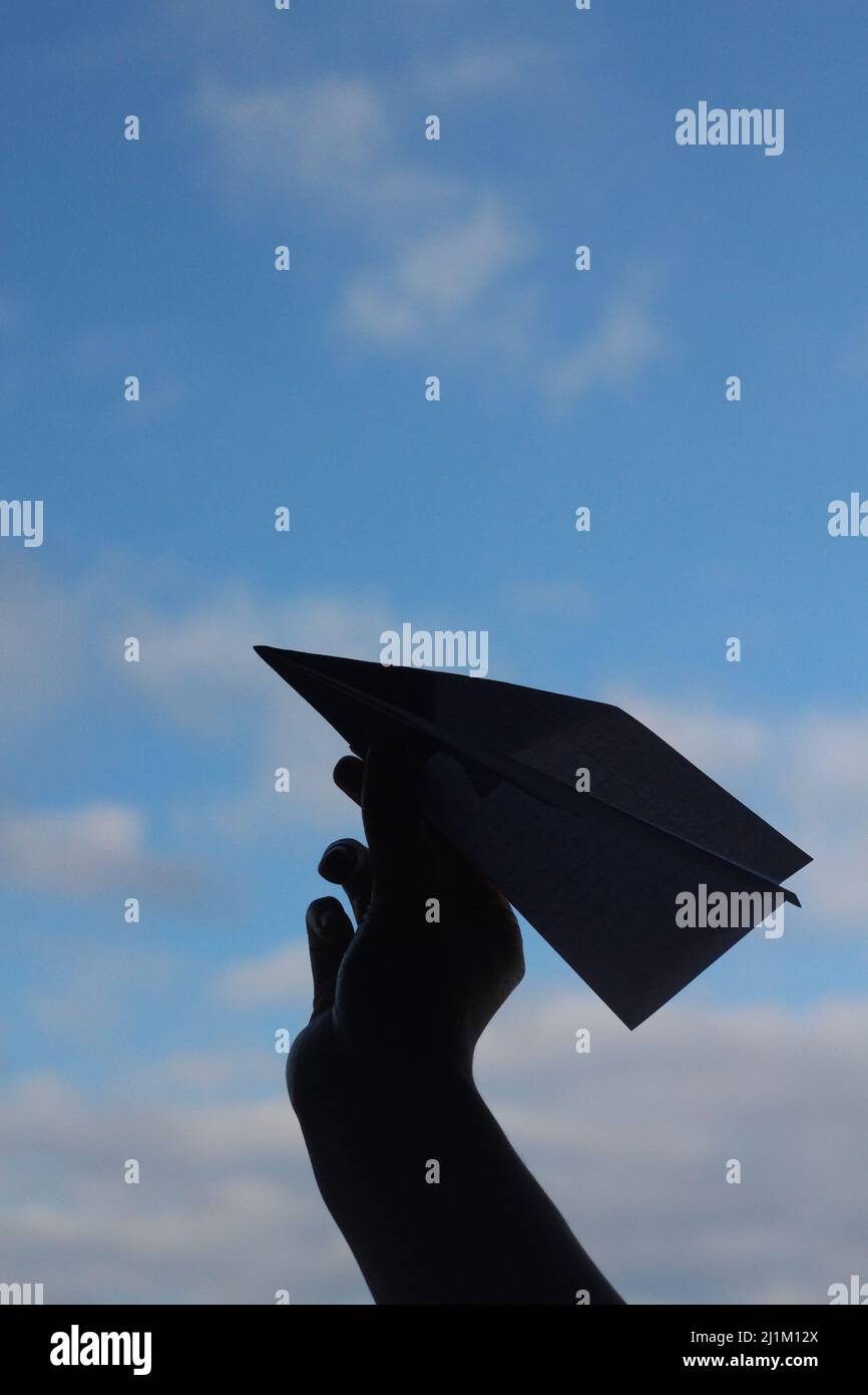 Hand throwing paper plane to blue sky, clear blue sky, sky background ...