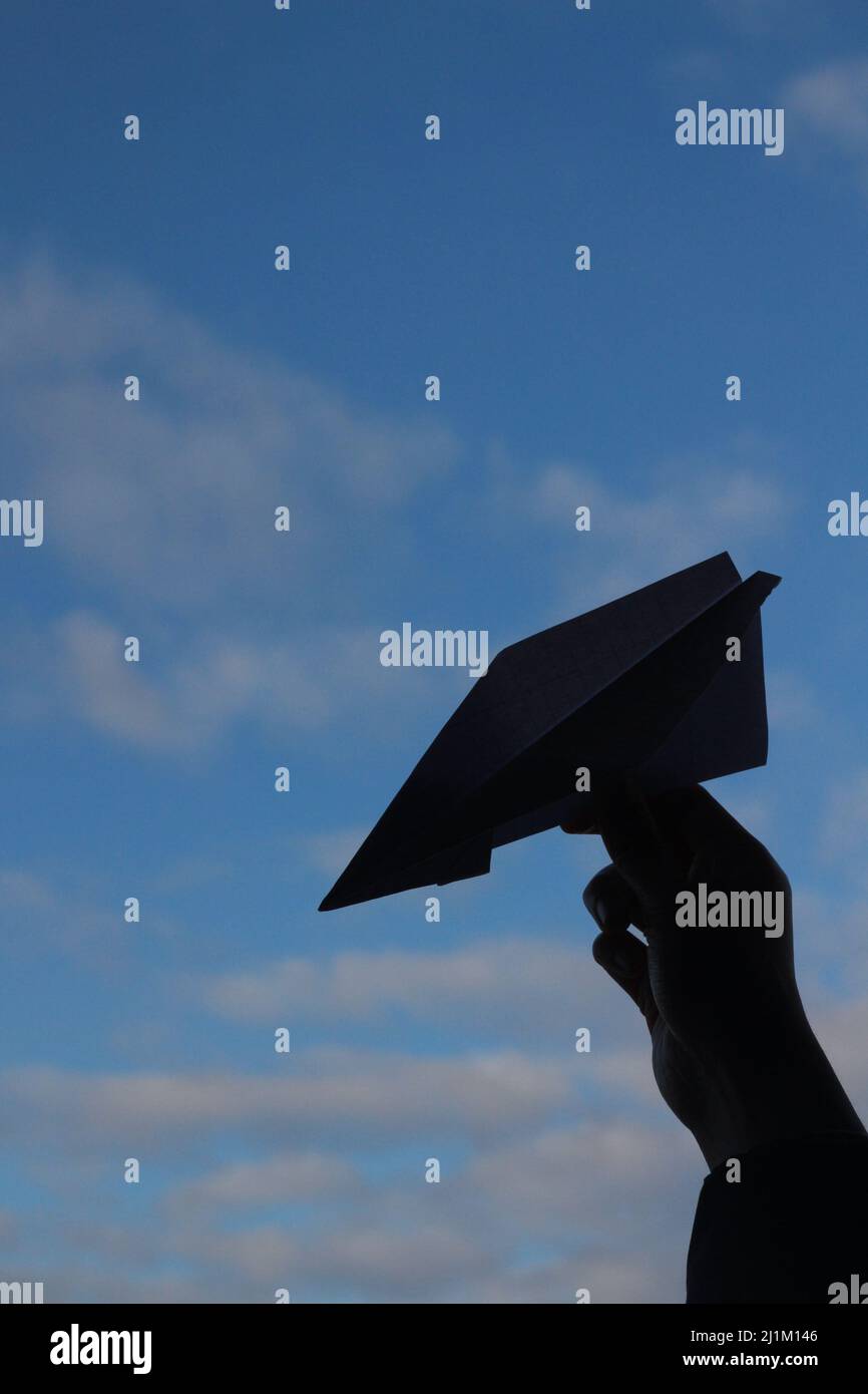Hand throwing paper plane to blue sky, clear blue sky, sky background ...